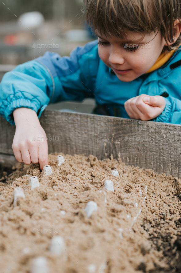 spring planting seeding farm garden. kid boy farmer gardener plants and ...