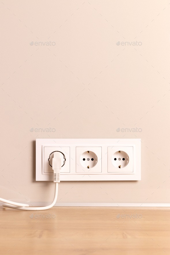Electrical outlets with plug on beige wall Stock Photo by Bykfa | PhotoDune
