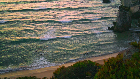 Sunset cliff beach coastline on tranquil evening. Scenery waves washing ...