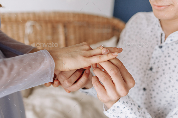 Close up young man putting wedding ring on woman bride finger, loving ...