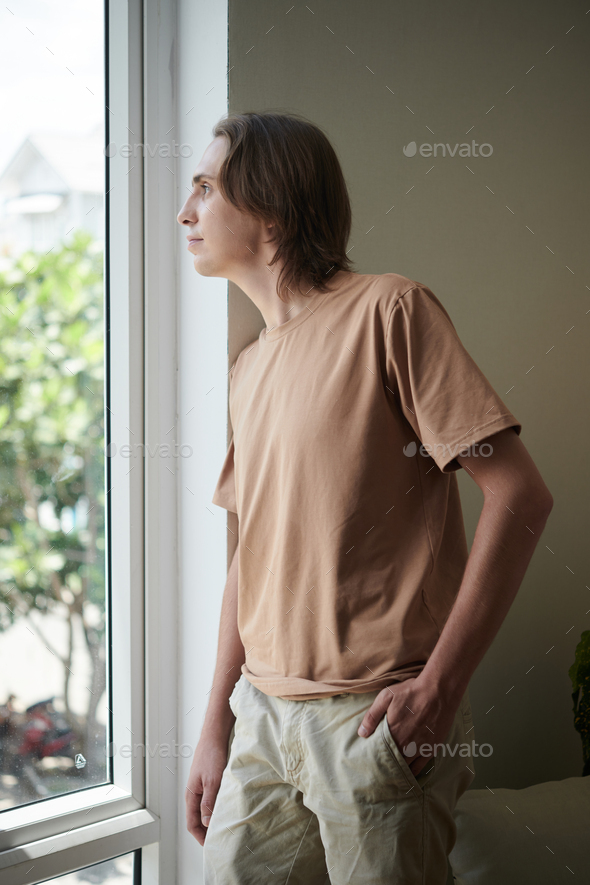 Man Looking outside through Window Stock Photo by DragonImages | PhotoDune