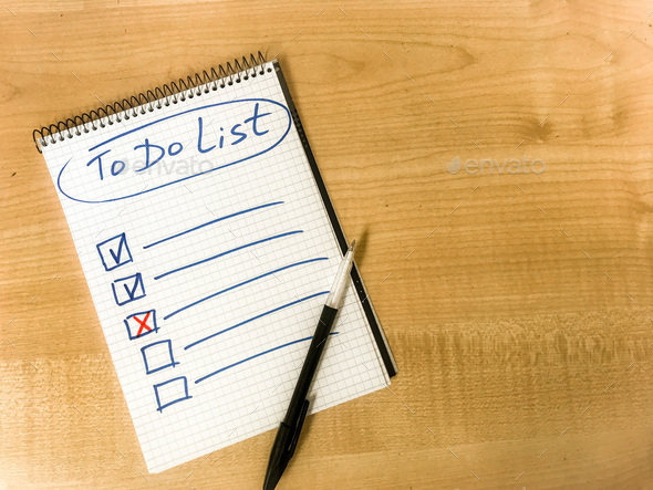 to do list checklist hand written on notepad paper lay on wooden table ...