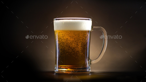 Glass of light beer on black background with spot light Stock Photo by ...
