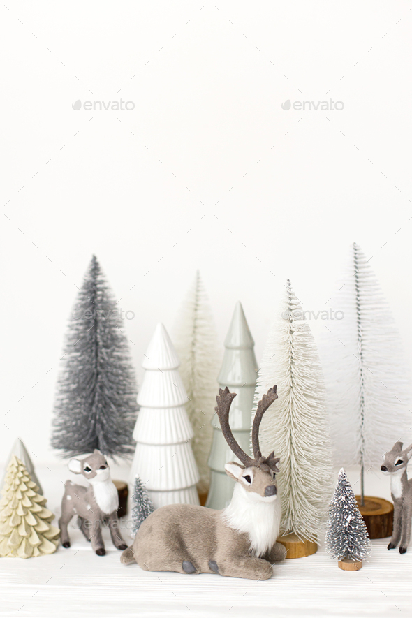 Stylish little Christmas trees and reindeer toys on white background ...
