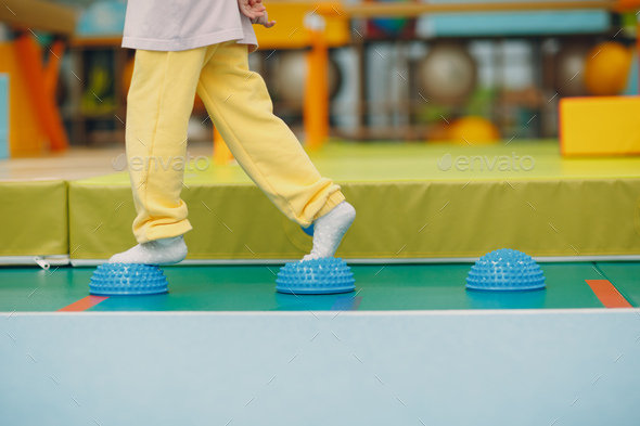 Kids doing massage hedgehog for foot legs exercises in gym at ...