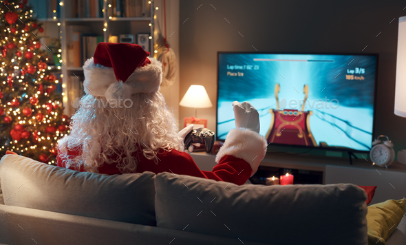 Funny Santa Claus playing video games at home Stock Photo by stockasso