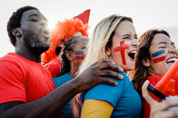 Crazy sport football fans in crowd celebrate red and blue team victory ...