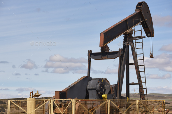 Rusty oil pumping machine. Pump jack. Petroleum extraction. Global ...