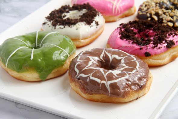 Freshly made assorted flavored donuts Stock Photo by junpinzon | PhotoDune