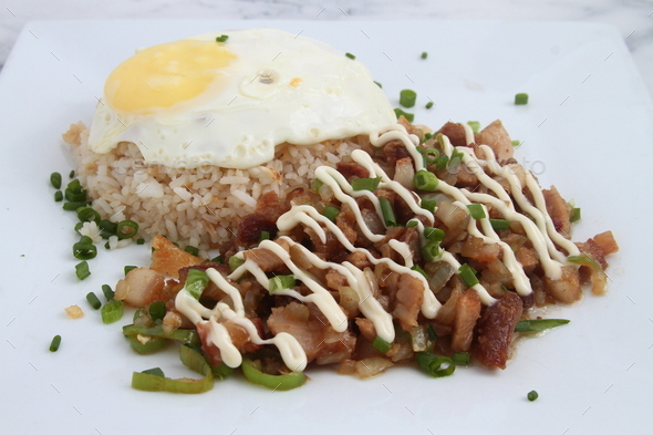 Freshly cooked Filipino food called Sisig silog Stock Photo by junpinzon