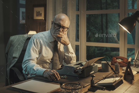 Professional businessman typing with a typewriter and thinking Stock ...