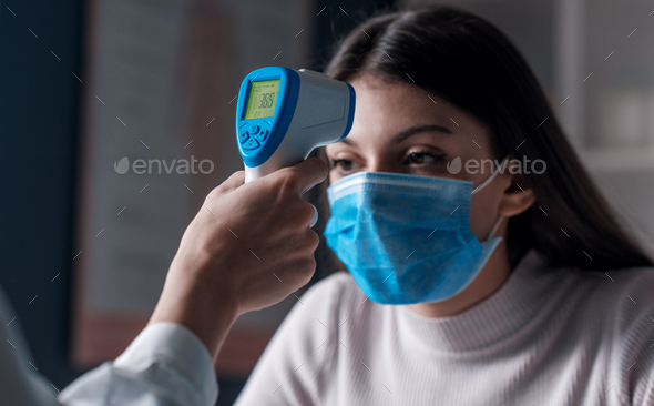 Body temperature check with infrared thermometer Stock Photo by stockasso