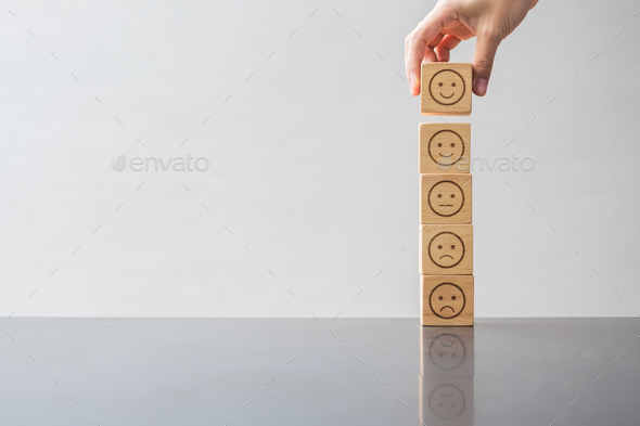 Man hand holding emotion face block. Stock Photo by JoPanwatD | PhotoDune