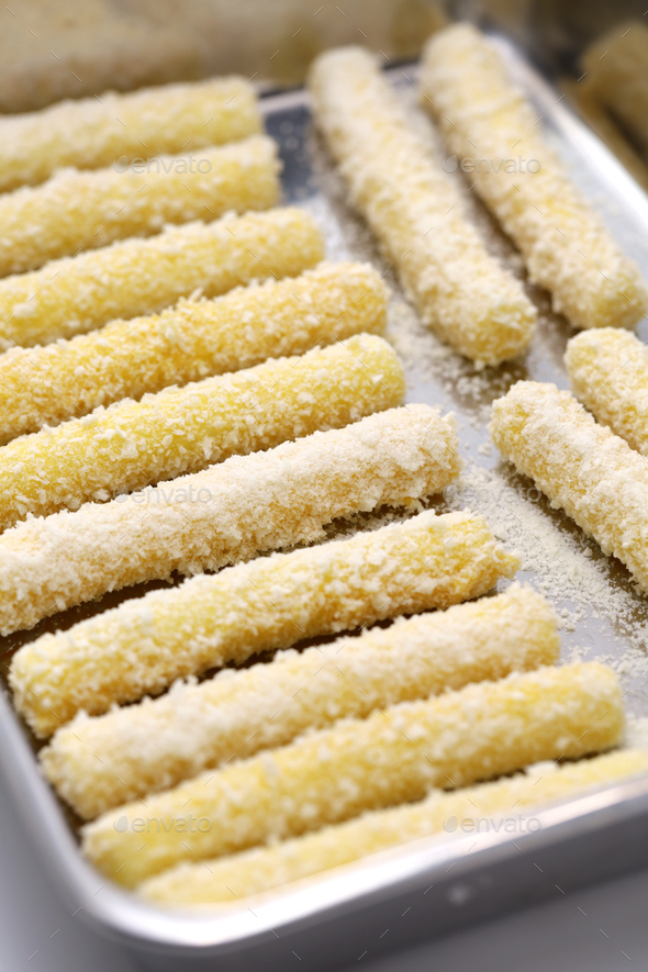 Mozzarella sticks with breaded crumbs in cooking tray ( Preparing to ...