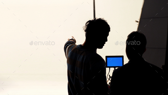 Movie director and photographer are talking. Stock Photo by gnepphoto