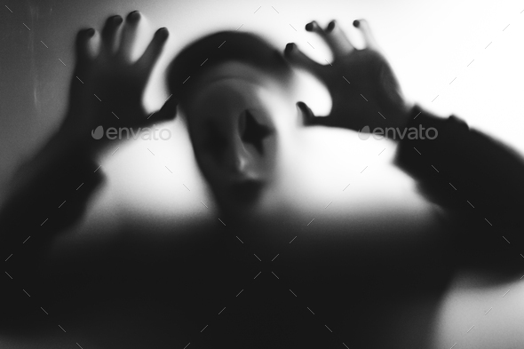 Shadowy figure behind glass - horror background Stock Photo by erika8213