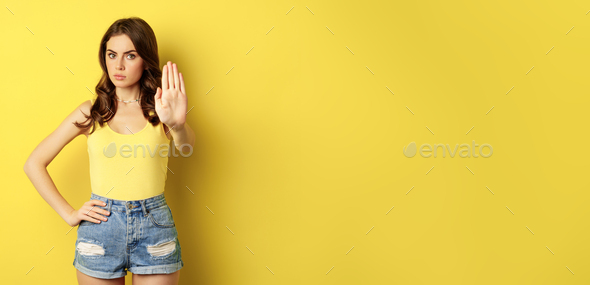 Serious stylish woman showing stop, rejection, prohibition gesture ...