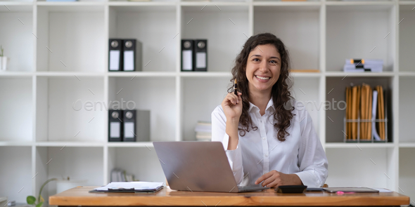 Photo of cheerful young woman working using computer laptop ...