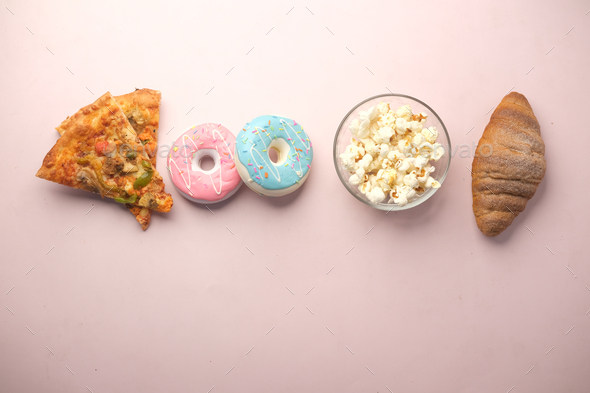 Slice of cheese pizza , donuts and popcorn on pink Stock Photo by towfiqu98