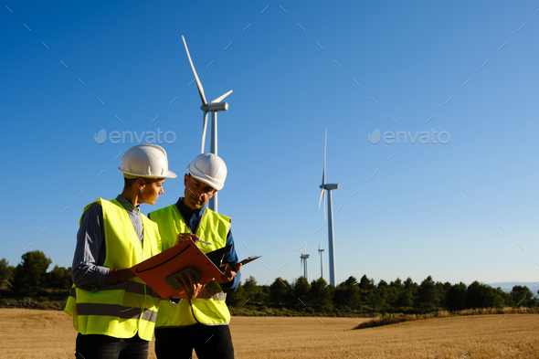 Two engineers working together in a wind turbine field. Stock Photo by ...