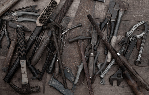 Collection of old woodworking handtools on a rough workbench wooden ...