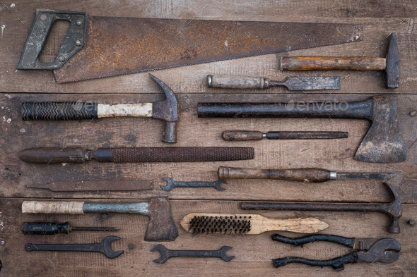 Collection of antique woodworking handtools on a rough workbench old ...