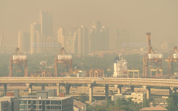 Blur photo of cityscape with polluted air. Air pollution. Smog and fine dust of pm 2.5 covered ...