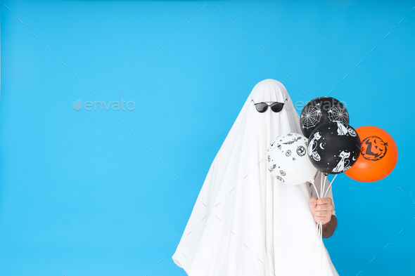 Concept of Halloween, Ghost in sunglasses on blue background Stock ...
