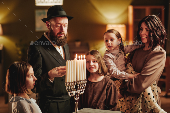 Jewish Family Celebrating Hanukkah Stock Photo by seventyfourimages
