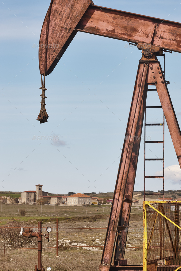 Rusty oil pumping machine. Pump jack. Petroleum extraction. Global ...