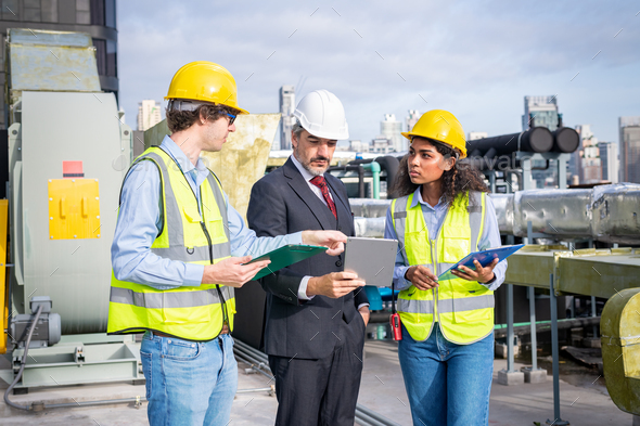 Manager and engineer project looking document tablet checking building ...