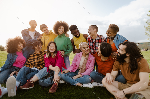 Group of young multiracial friends having fun together in park ...