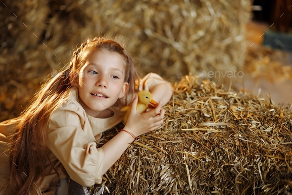 Farm girl sitting on hay with ducks Stock Photo by kaplickaya | PhotoDune