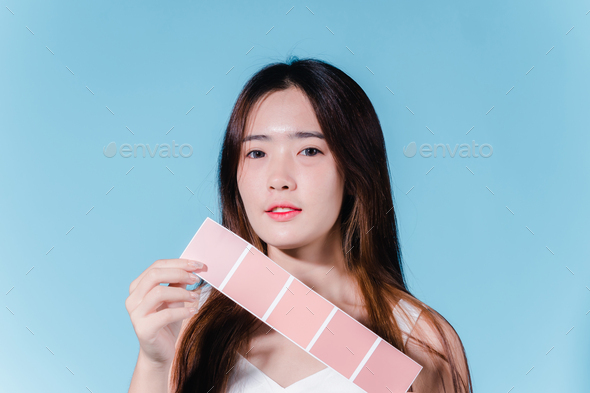 Charming asian beauty woman take color scale on the blue background ...