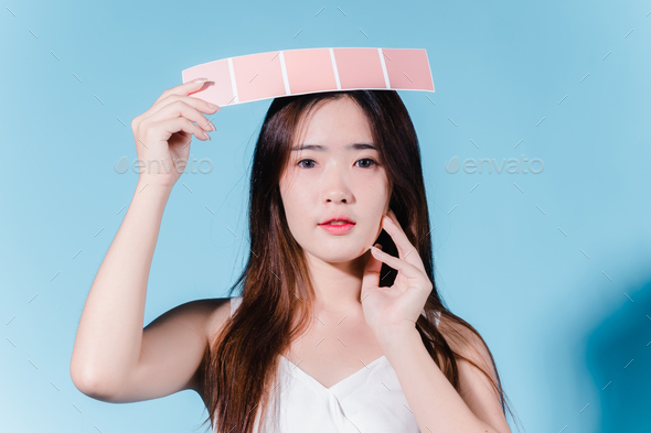 Charming asian beauty woman take color scale on the blue background ...