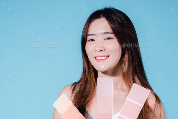 Charming asian beauty woman take color scale on the blue background ...