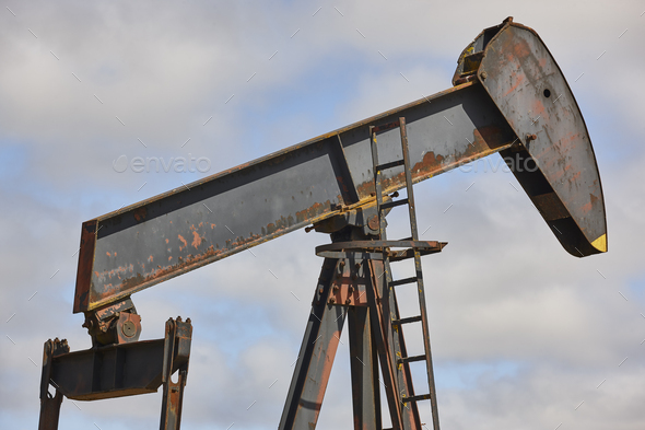 Rusty oil pumping machine. Pump jack. Petroleum extraction. Global ...