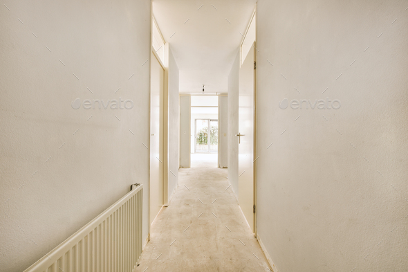 Narrow simple corridor with doors and lamp Stock Photo by pro_creator
