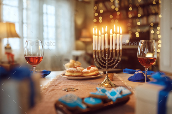 Menorah with lit candles on the table during Jewish festival of lights ...