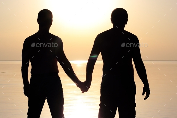 Romantic couple of men at sunset Stock Photo by larisikstefania | PhotoDune