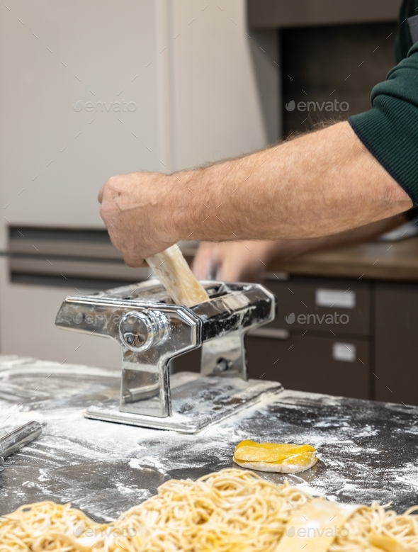 The process of making homemade pasta using a pasta machine. Stock Photo ...