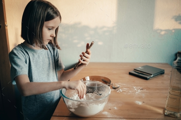 A girl cooks a pie in the kitchen, isolation exercise for a child Stock ...