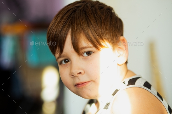 Little boy look at camera . Shadows and light in a face . Stock Photo ...