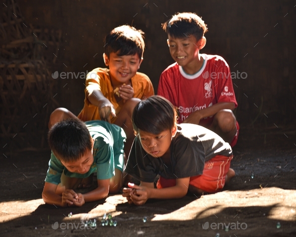 Children playing marbles Stock Photo by ekobudiutomo | PhotoDune