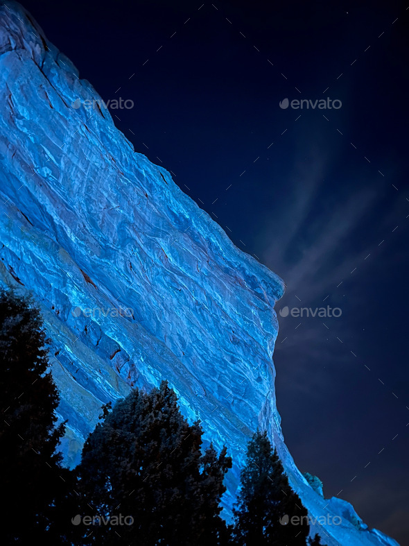 Red rocks lit up by a blue light at night during a concert at Red Rocks ...