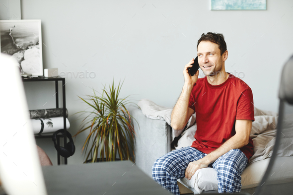 Man having conversation on mobile phone Stock Photo by seventyfourimages