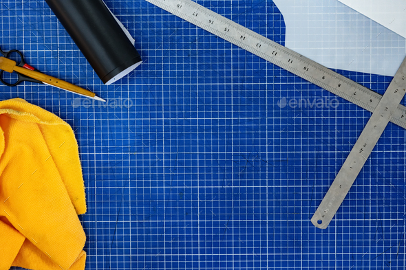 Desktop top view with blue cutting mat Stock Photo by FabrikaPhoto