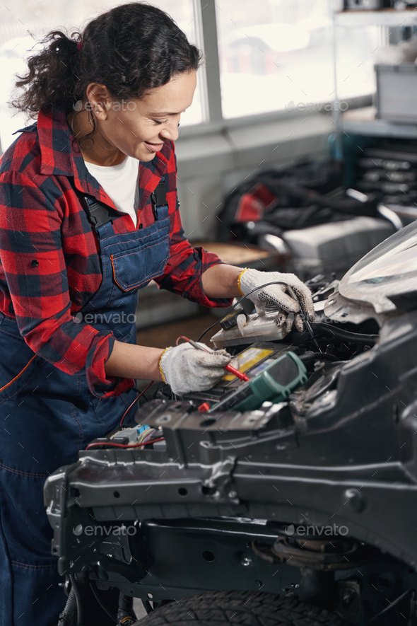 Positive delighted master checking voltage in the engine Stock Photo by ...
