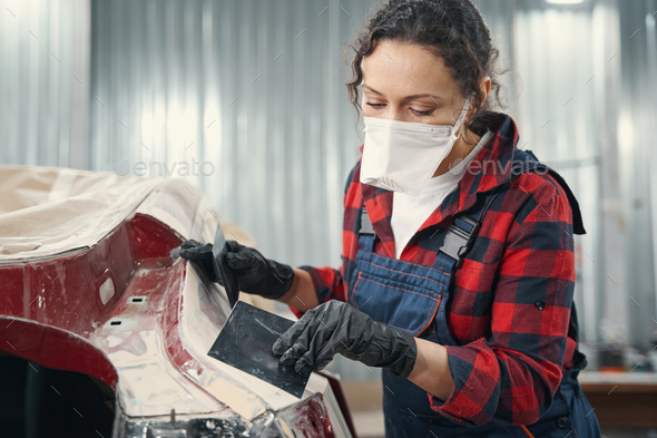 Concentrated female mechanic preparing car for repaint Stock Photo by ...