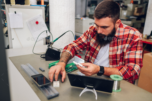 Electronics engineer man hands repairing computer part in service ...